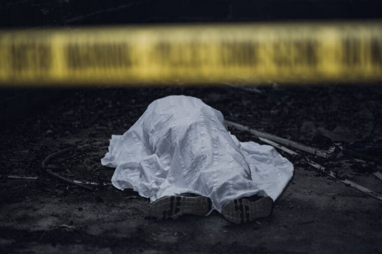 Dead body on the ground behind a cordon tape - Eye of the Flyer